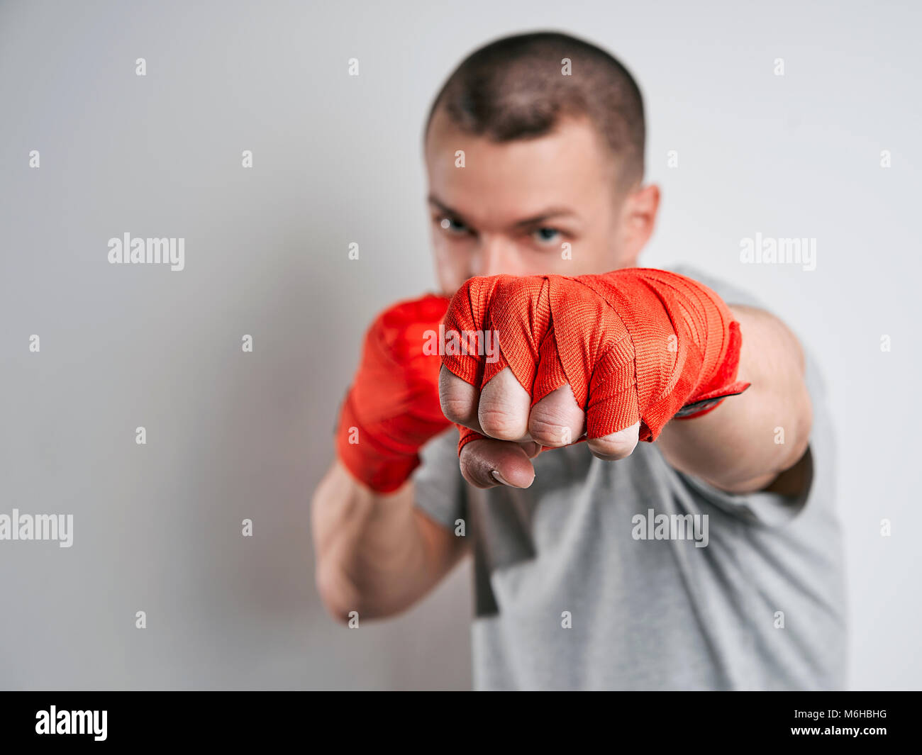 man in red Boxing bandages white background Stock Photo - Alamy