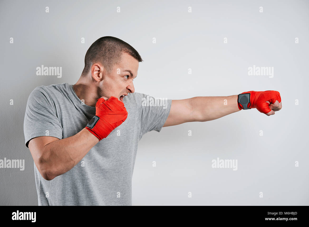man in red Boxing bandages white background Stock Photo - Alamy