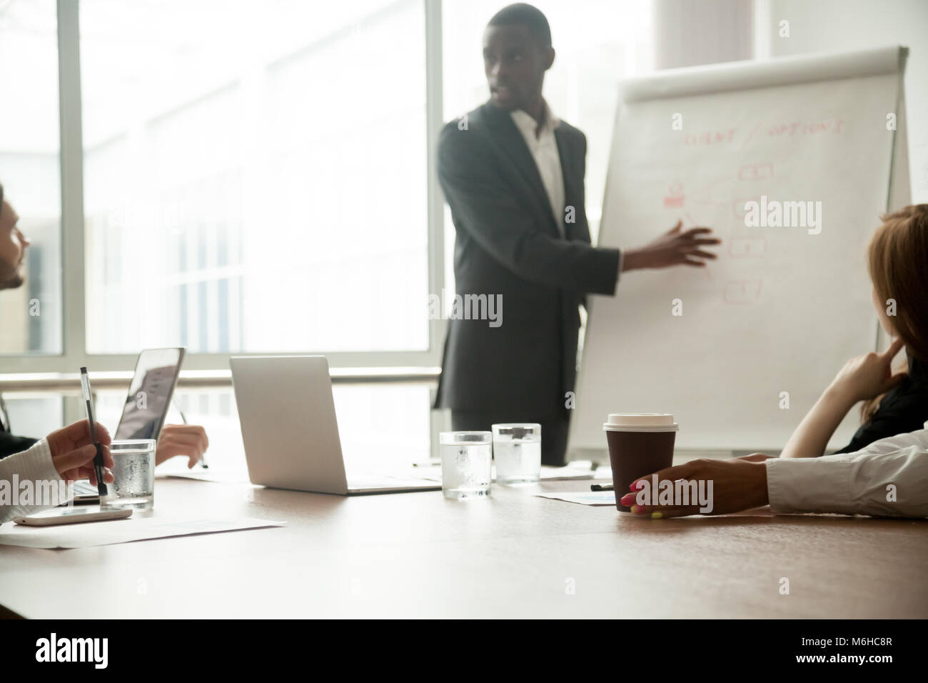 African-american coach giving presentation for businesspeople in Stock ...