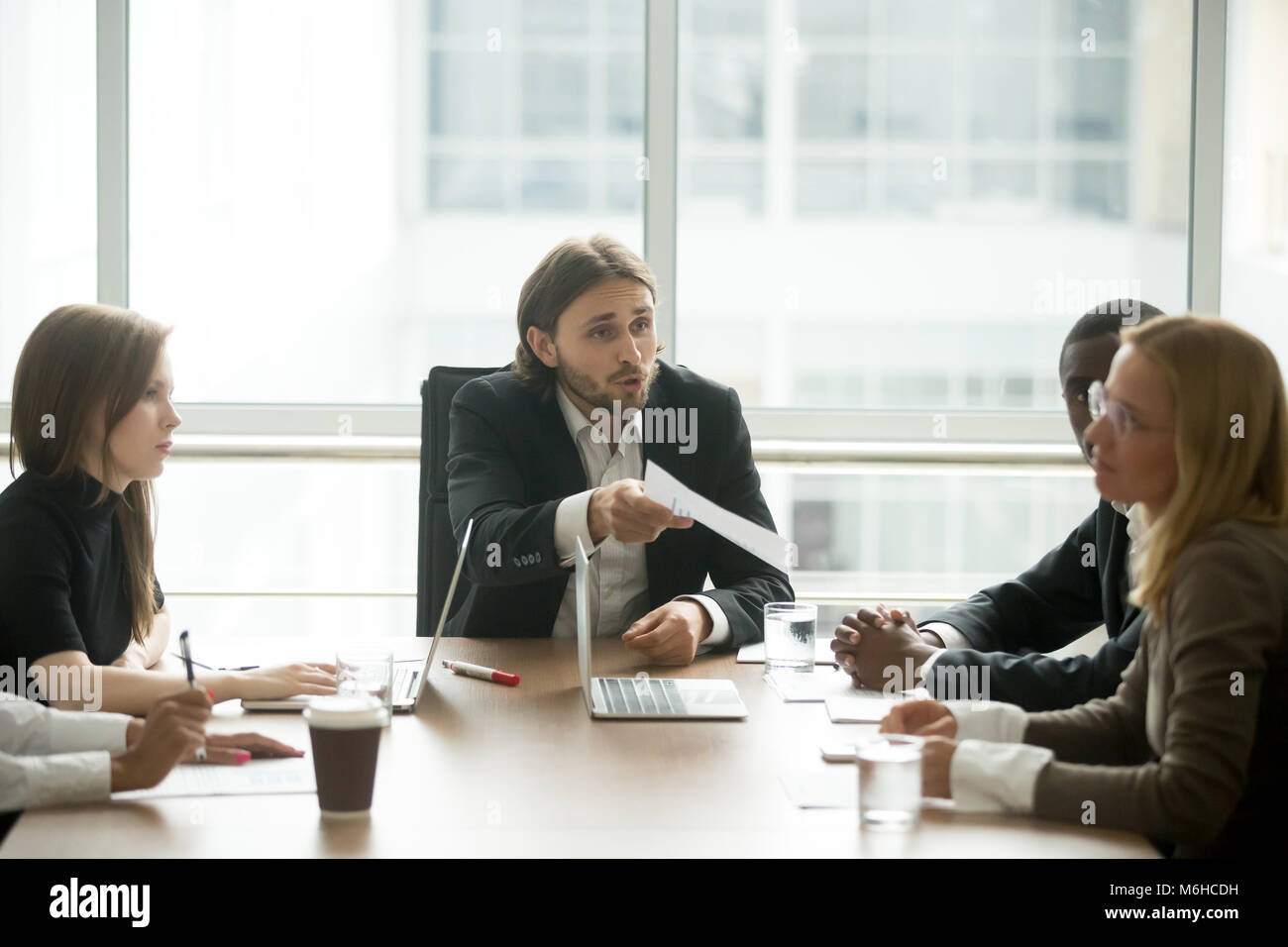 Angry boss reprimanding employee for bad work result at meeting Stock ...