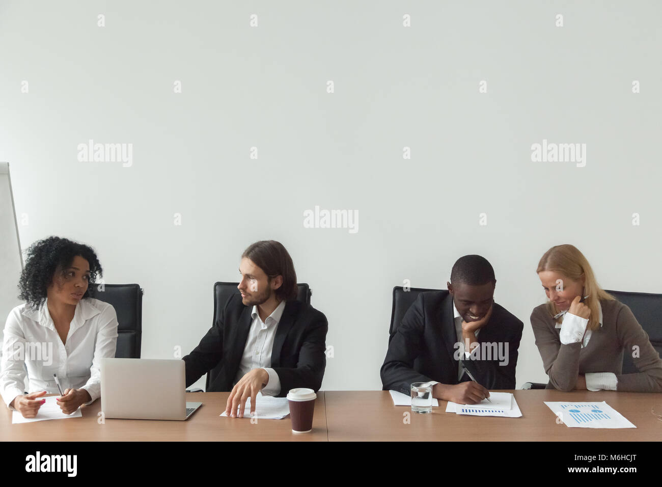 Diverse business people working talking at conference table, cor Stock ...