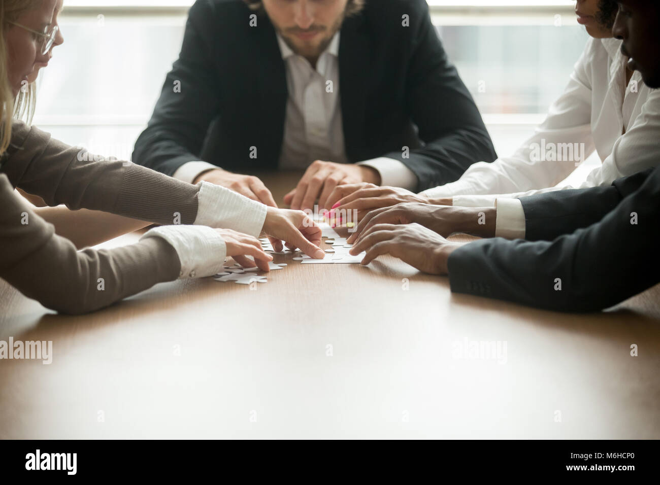 Multiracial business team assembling puzzle, help support in tea Stock ...