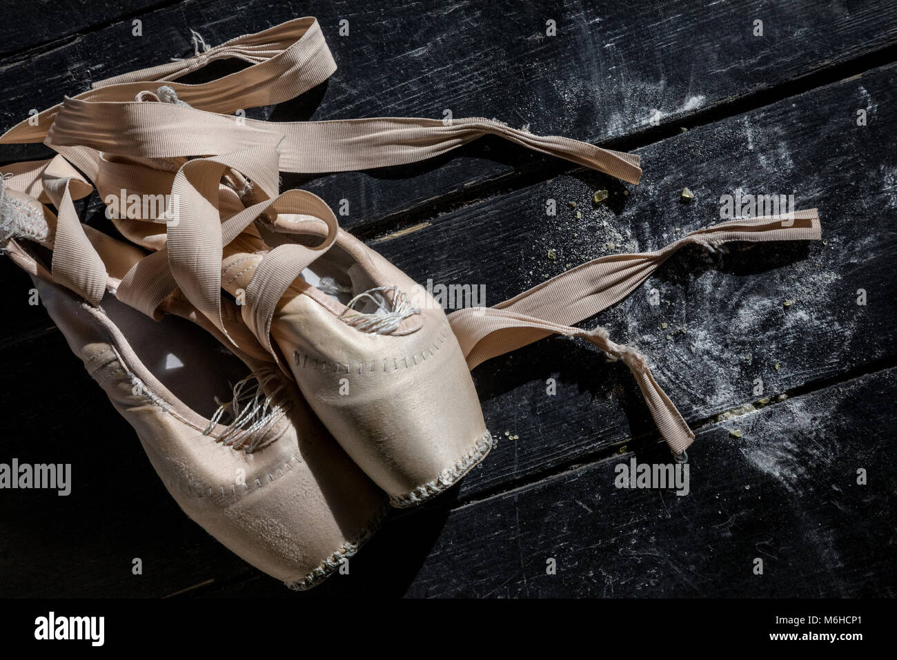Pointe shoes on wooden background on theater stage Stock Photo - Alamy