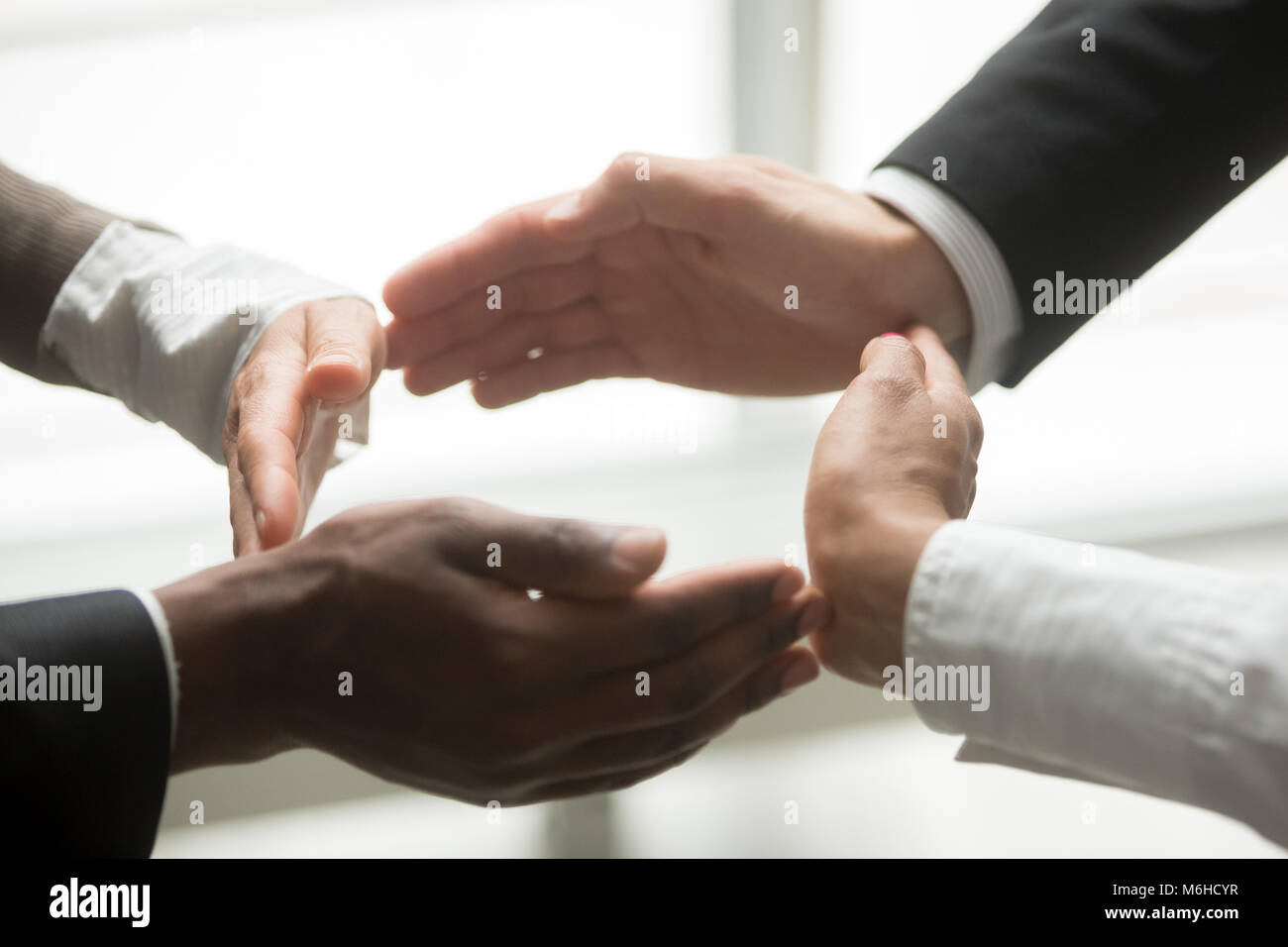 Hands together black white multiracial hi-res stock photography and ...