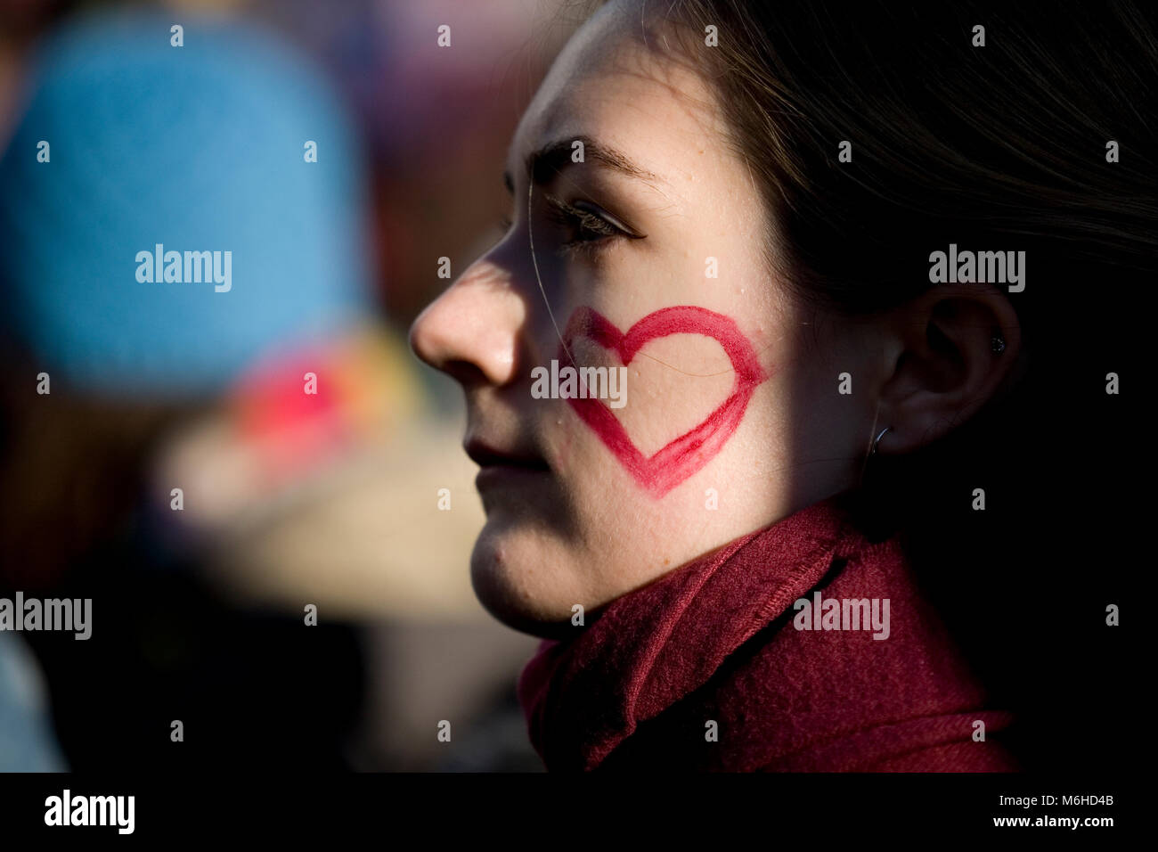 Young woman with heart face paint during the women's march on London ...