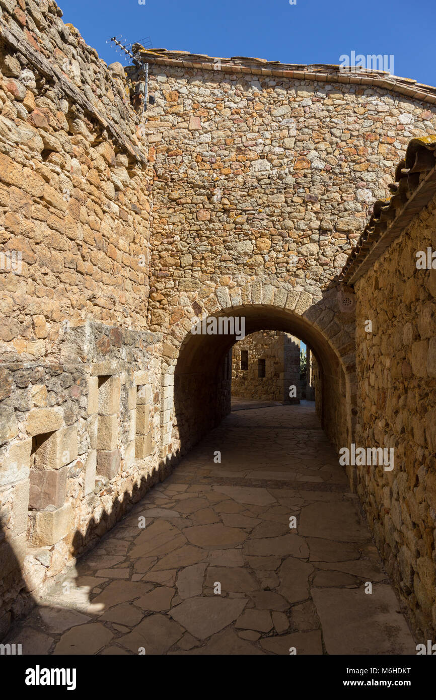 Beautiful old stone arcs in Spanish ancient village, Pals, in Costa ...