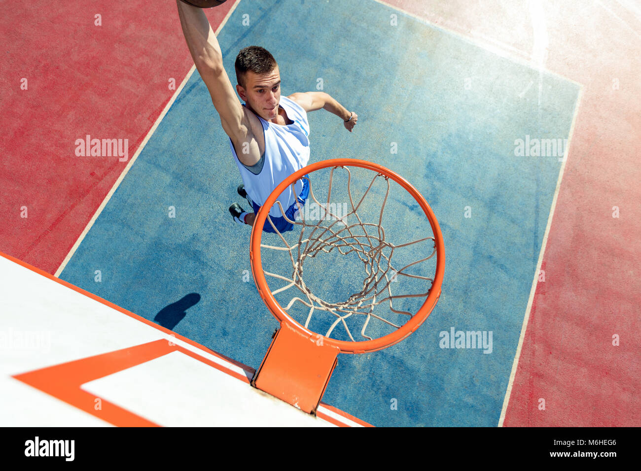 High angle view of basketball player dunking basketball in hoop Stock ...