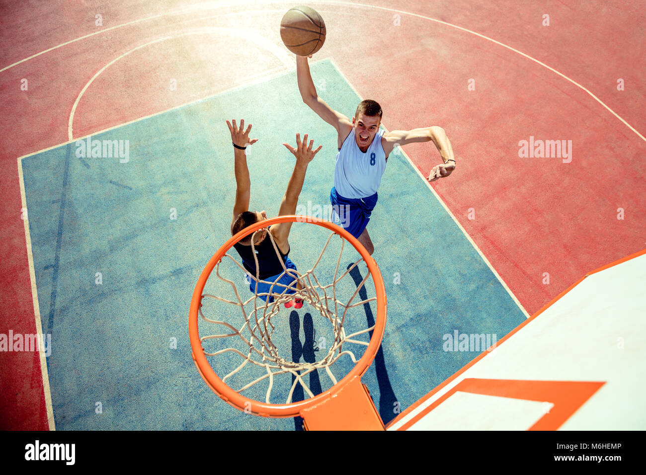 High angle view of basketball player dunking basketball in hoop Stock ...