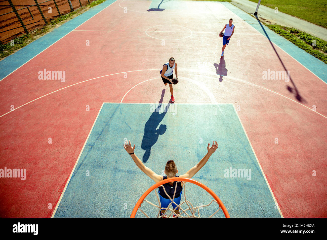 High angle view of basketball player dunking basketball in hoop Stock ...