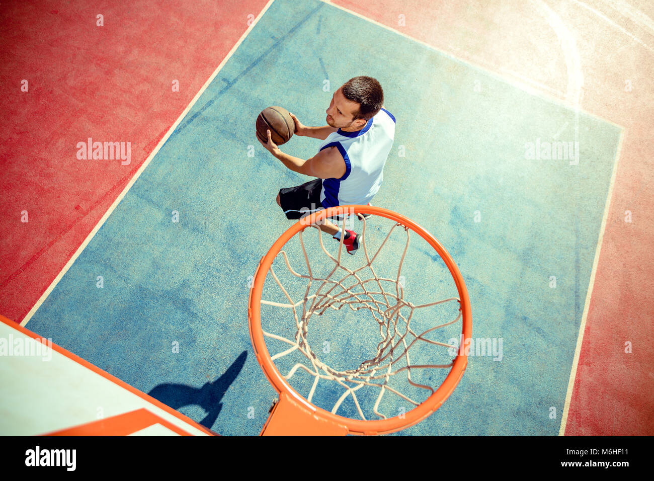 High angle view of basketball player dunking basketball in hoop Stock ...
