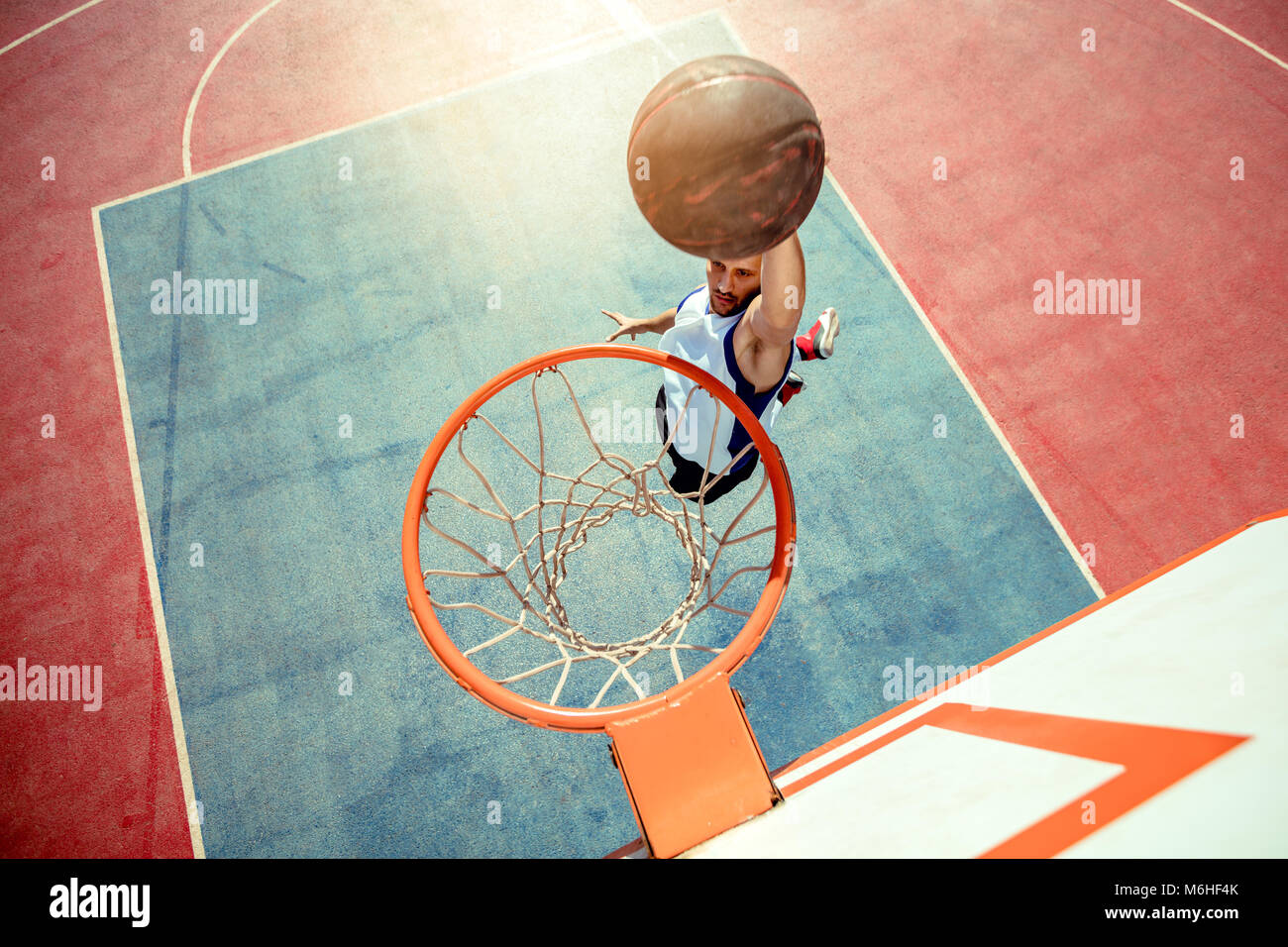 High angle view of basketball player dunking basketball in hoop Stock ...