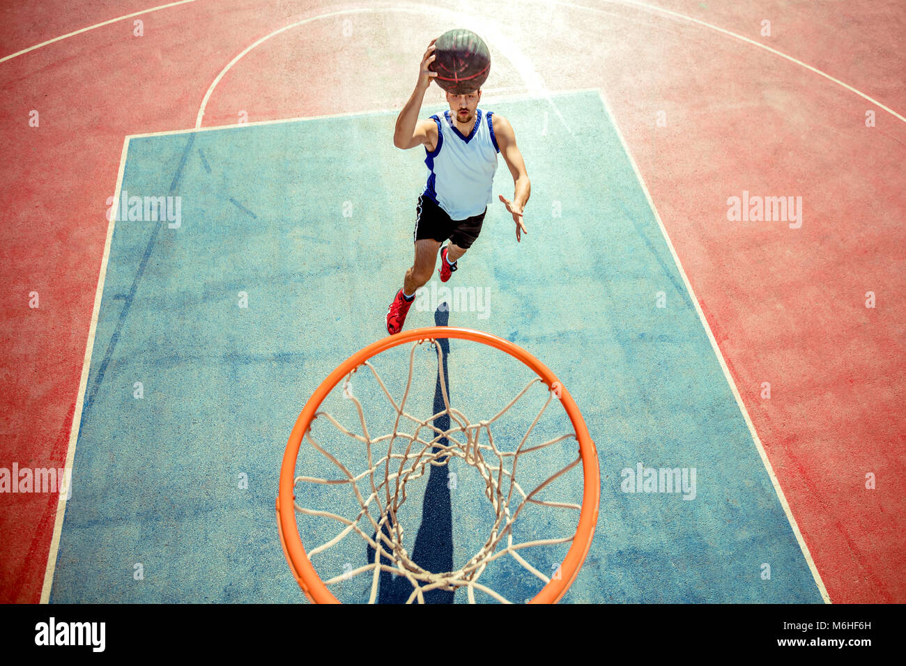High angle view of basketball player dunking basketball in hoop Stock ...