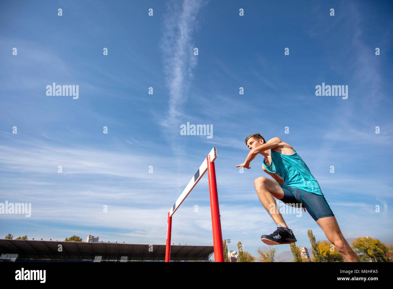 Male athlete jumping over obstacle people hi-res stock photography and ...