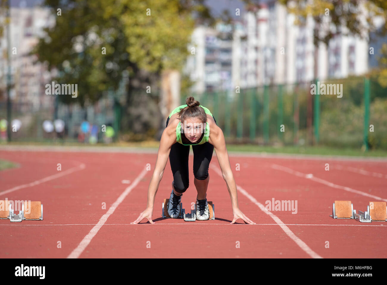 Female Sprinter Getting Ready to Start The Race Stock Photo - Alamy