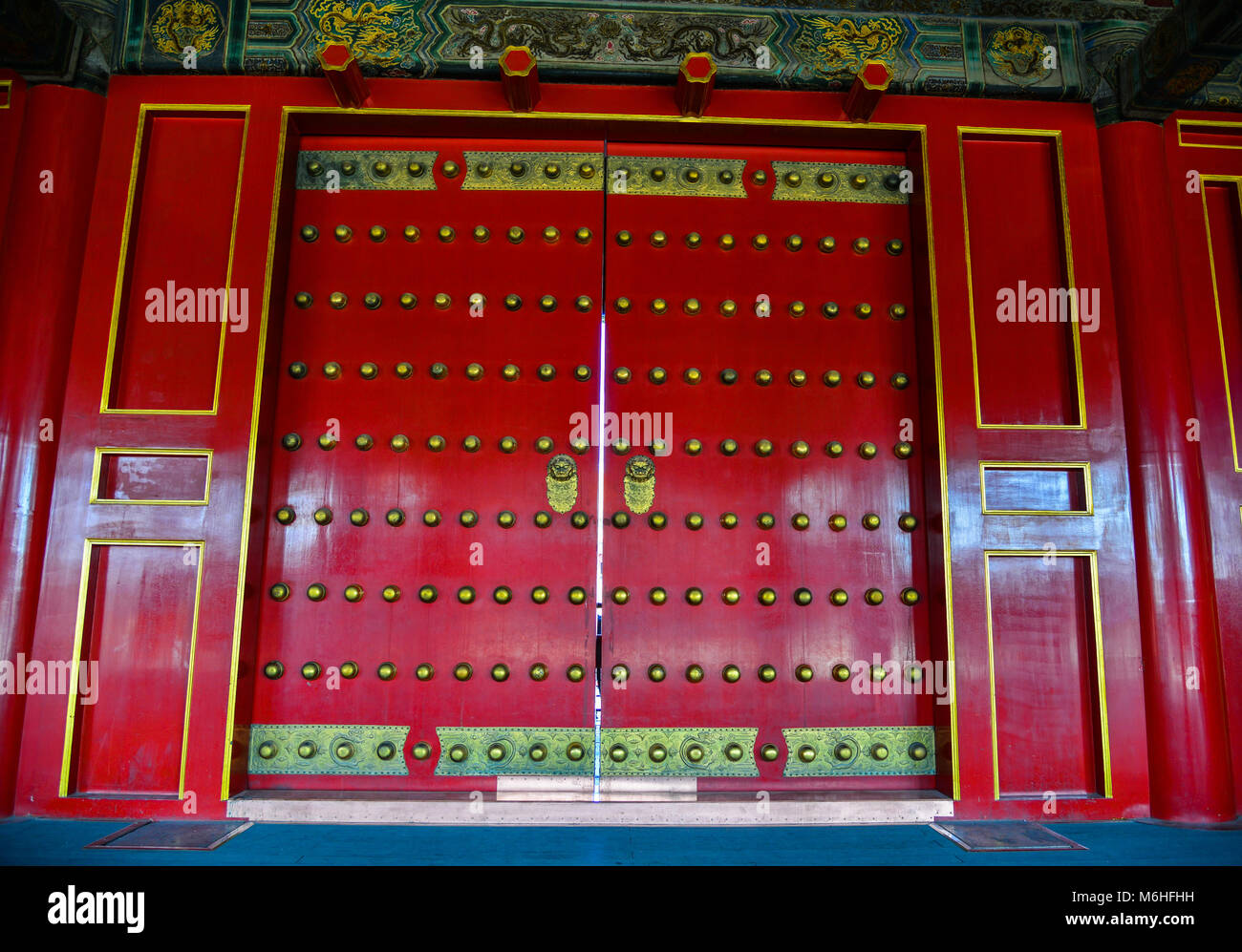 Ornate red wooden door with tile trim at the Forbidden City in Beijing ...