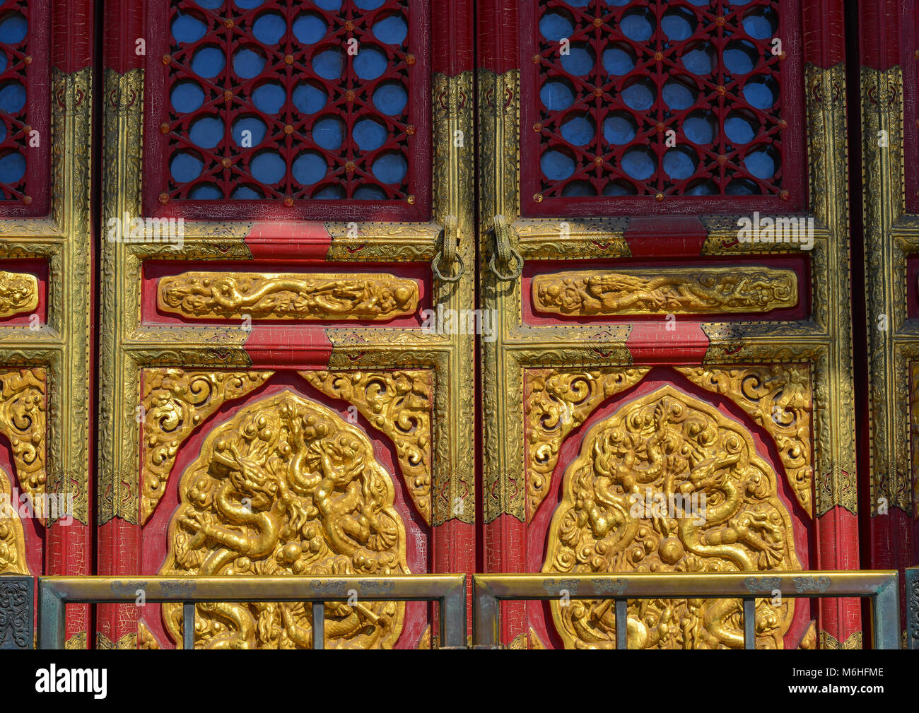 Ornate golden wooden door with tile trim at the Forbidden City in ...