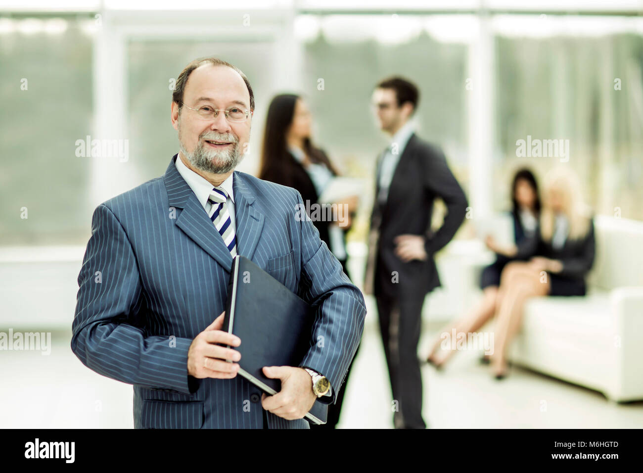 portrait of successful businessman with documents on the background of ...