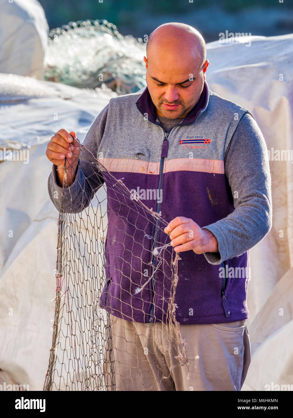 Mending fishing nets on Procida Island, Italy Stock Photo - Alamy