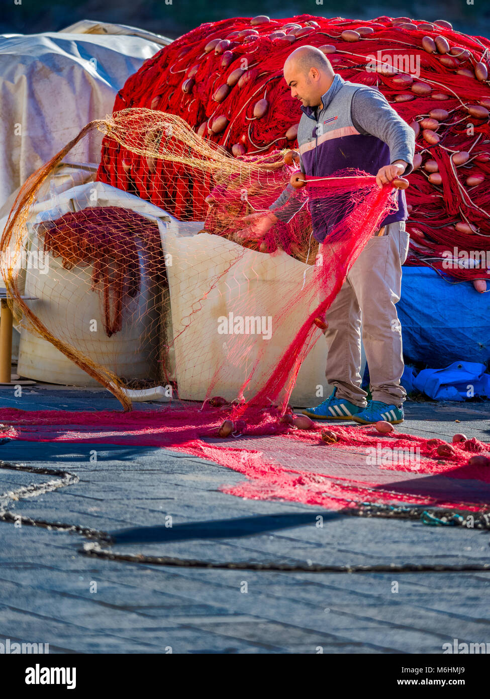 Reeling in fishing nets on Procida Island, Italy Stock Photo - Alamy