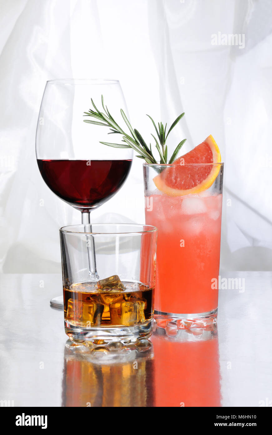 Paloma cocktail in Collins Glass, Whiskey in rocks glass with ice cubes ...