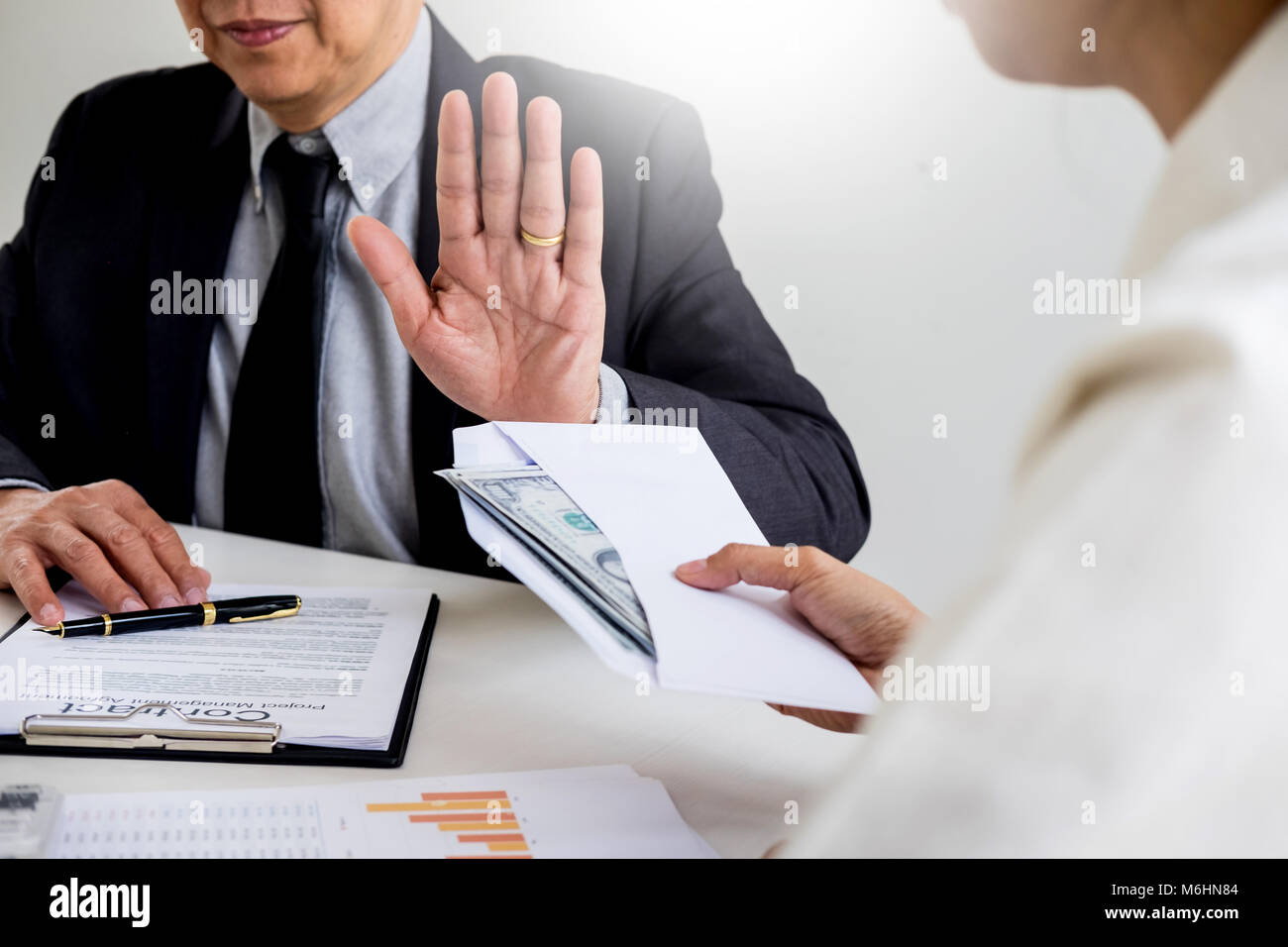 Businessman refusing or rejecting money in the envelope - anti bribery ...