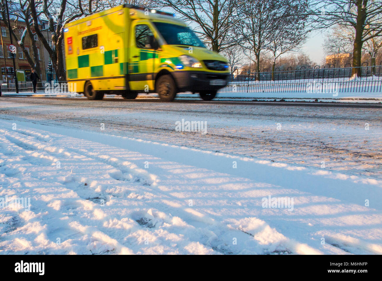 An ambulance races through the snow to attend an emergency Stock Photo ...