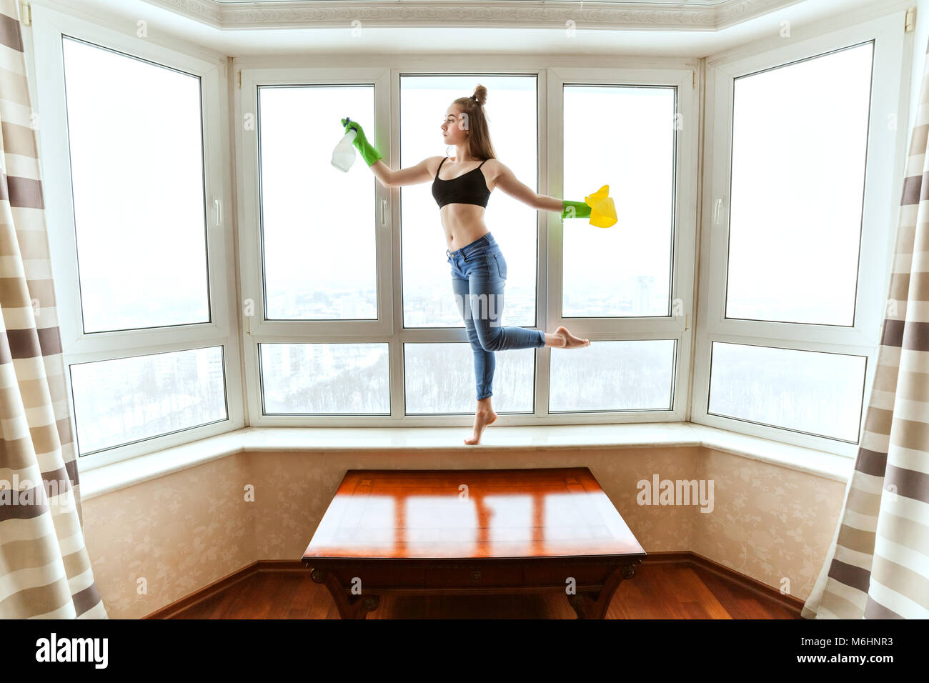 Woman washing windows during a dance, she does homework at home Stock ...