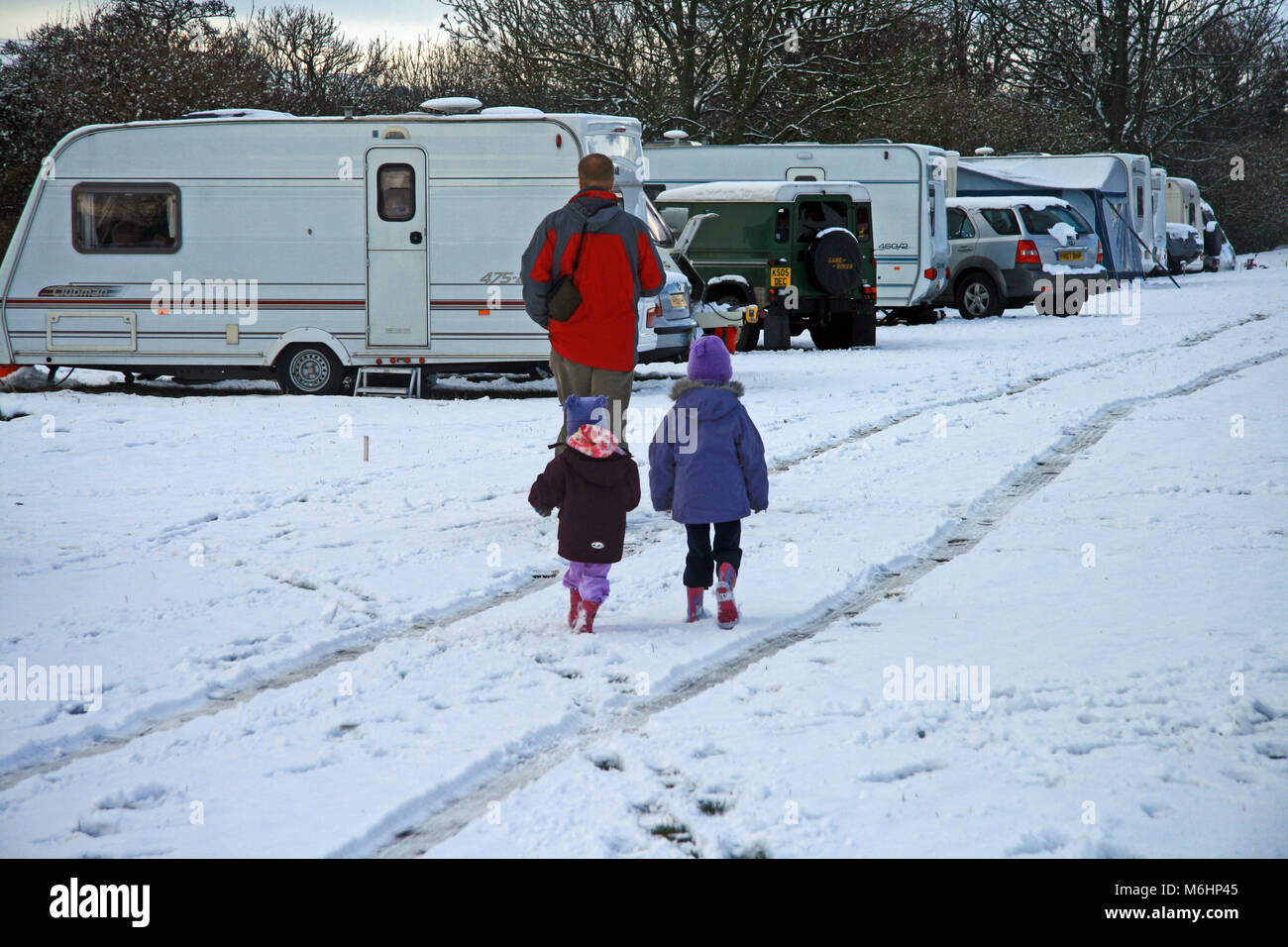 Man with two young children on a caravan and camping holiday rally in ...