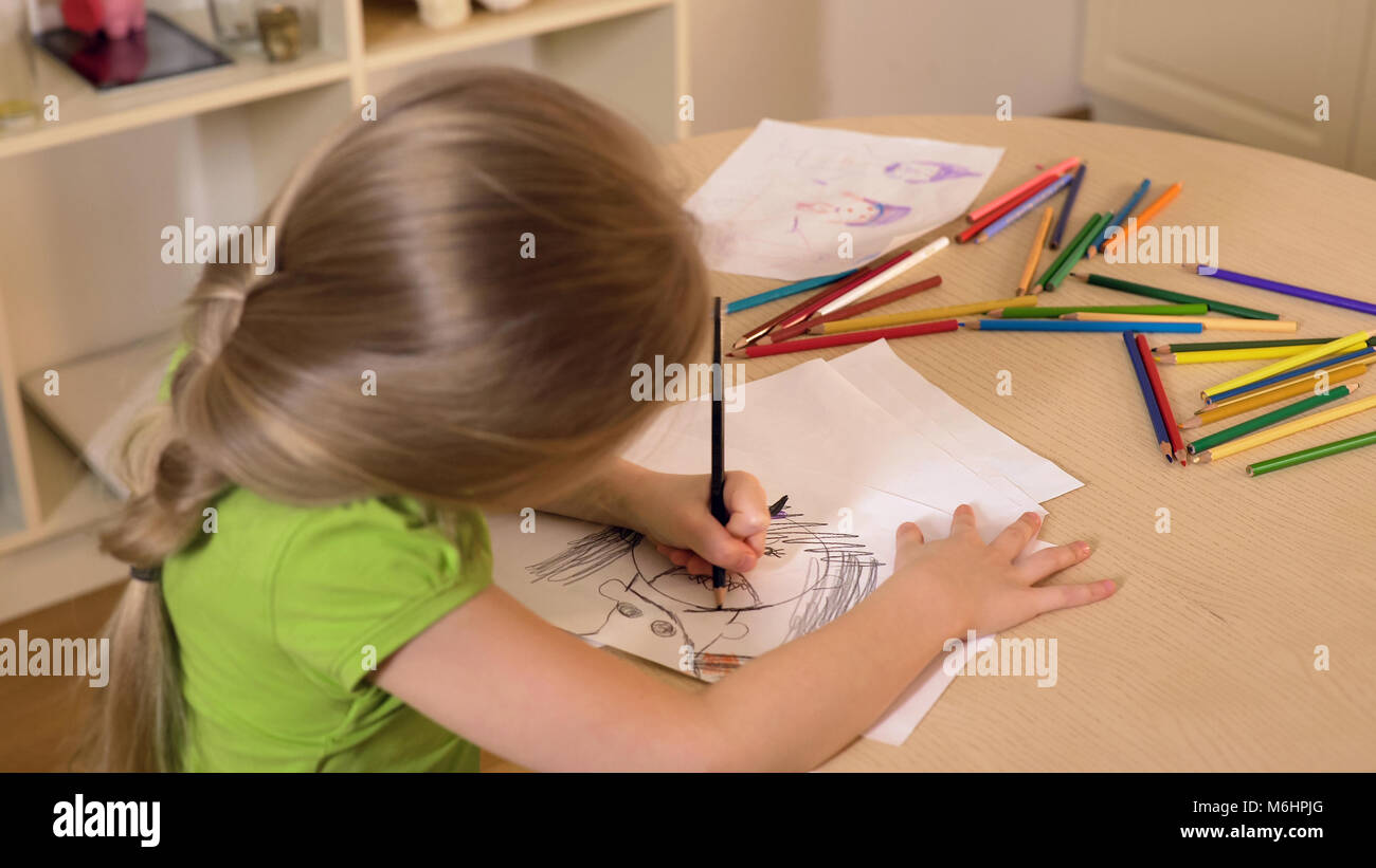 Girl drawing monster with black pencil, childhood fears, psychological ...