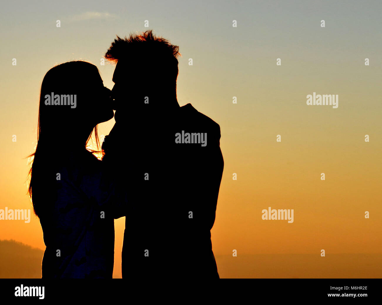 Shadows kissing at sunset Stock Photo - Alamy