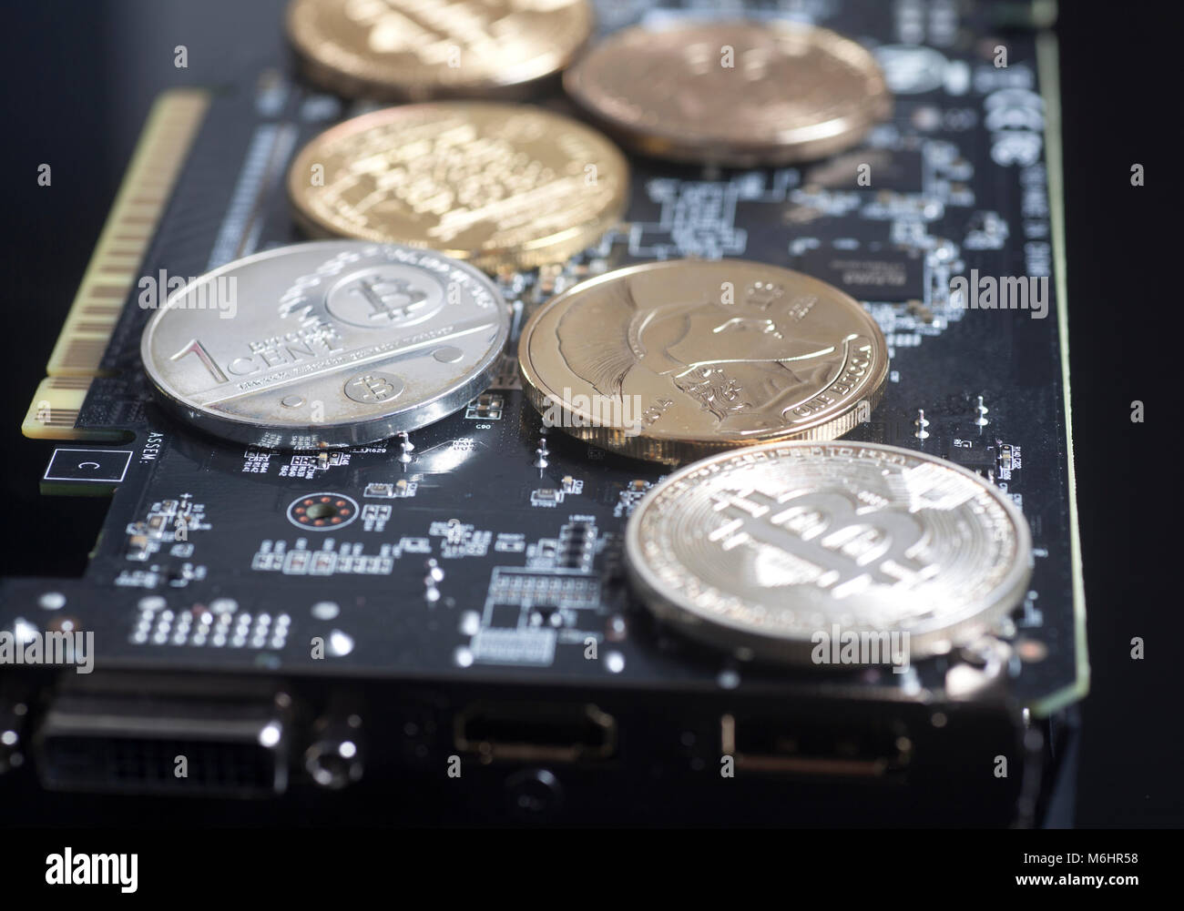 Cryptocurrency mining concept with bitcoins on a graphic videocard ...