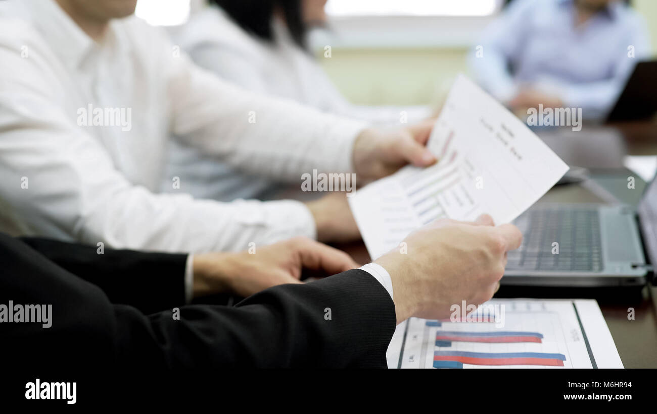 Two managers holding report document, developing company strategy ...