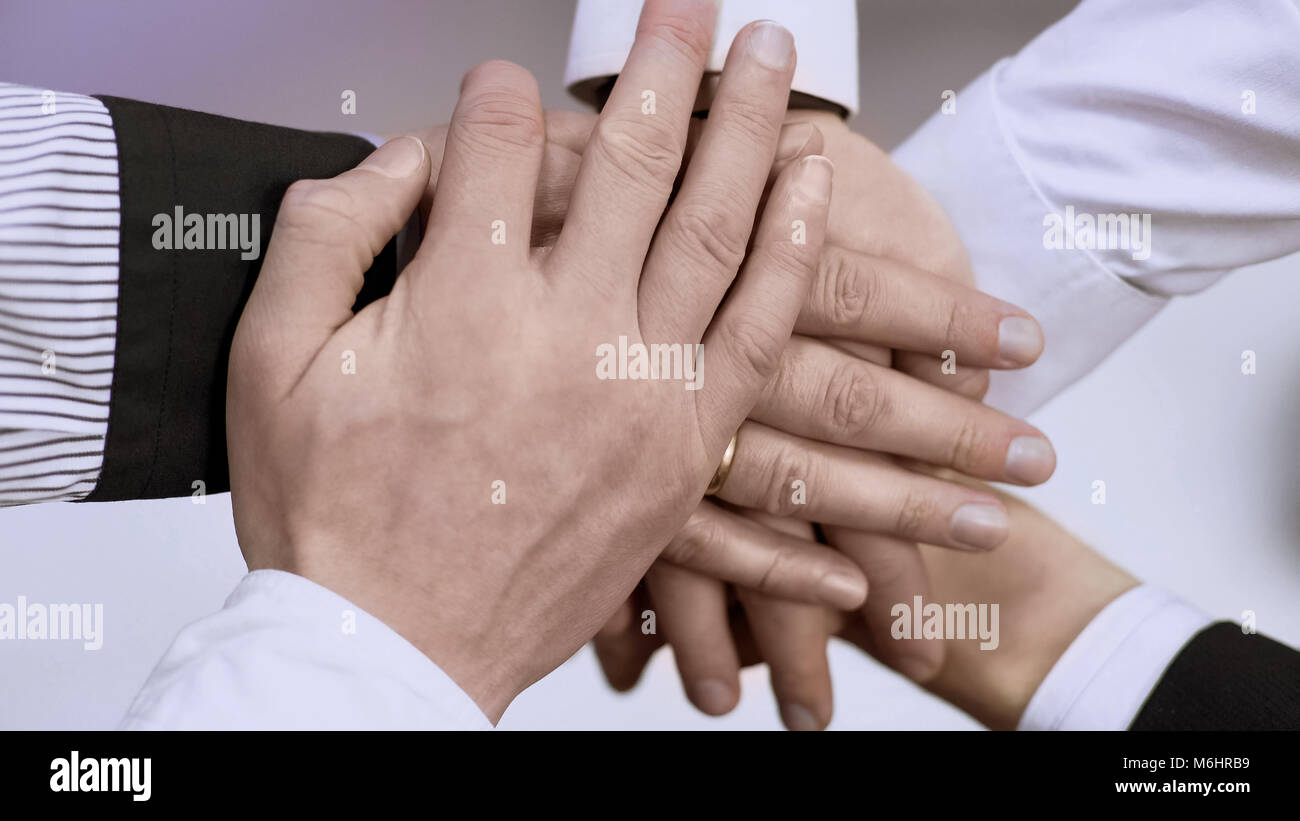 Group of business people holding hands together, symbol of teamwork and ...