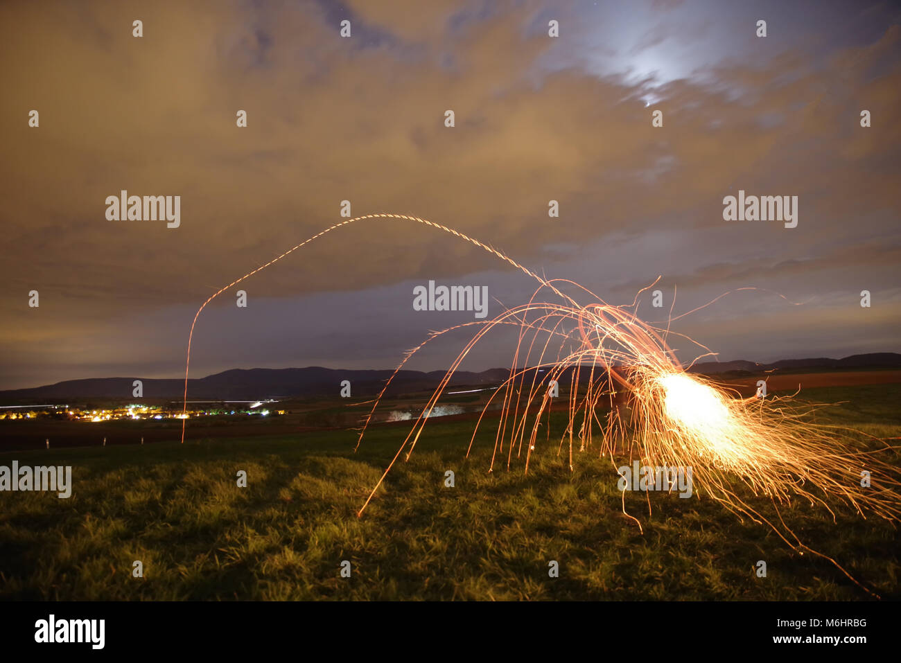 Fire streaks while launching a wooden disk at Schieweschlawe. This old ...