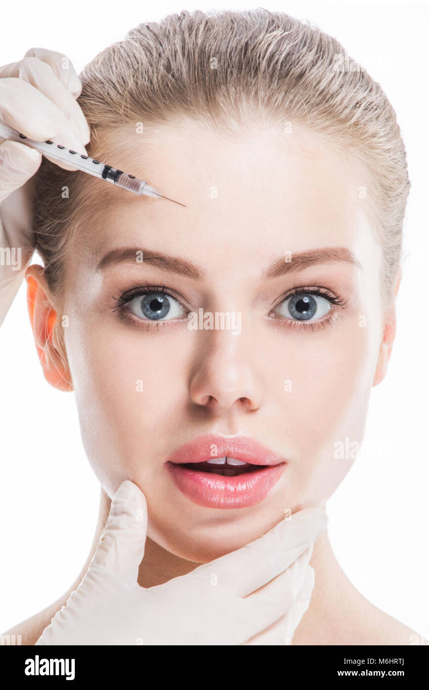 Beautiful woman gets an injection in her face isolated on white Stock ...