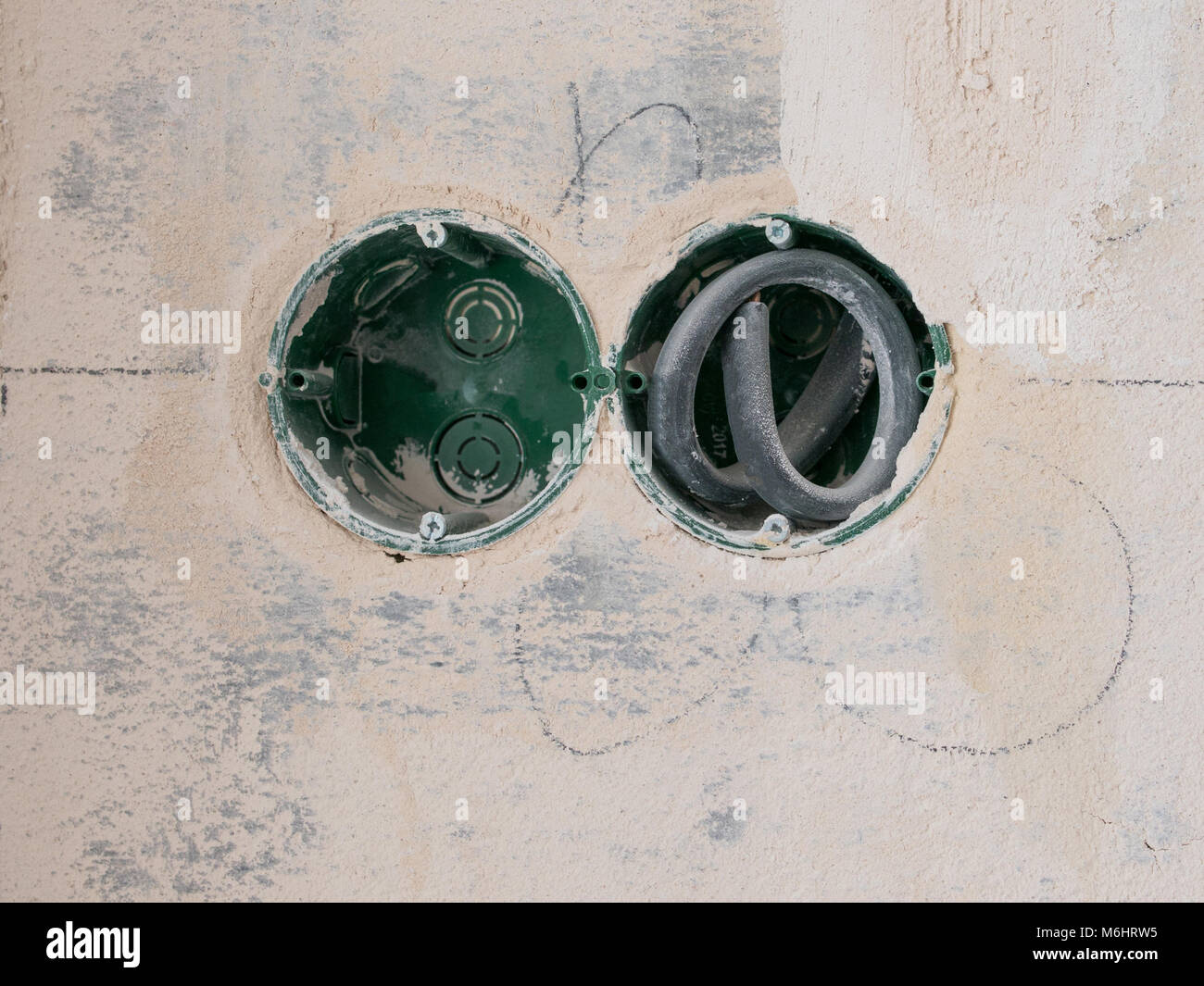 Double power socket hole in concrete wall Stock Photo - Alamy