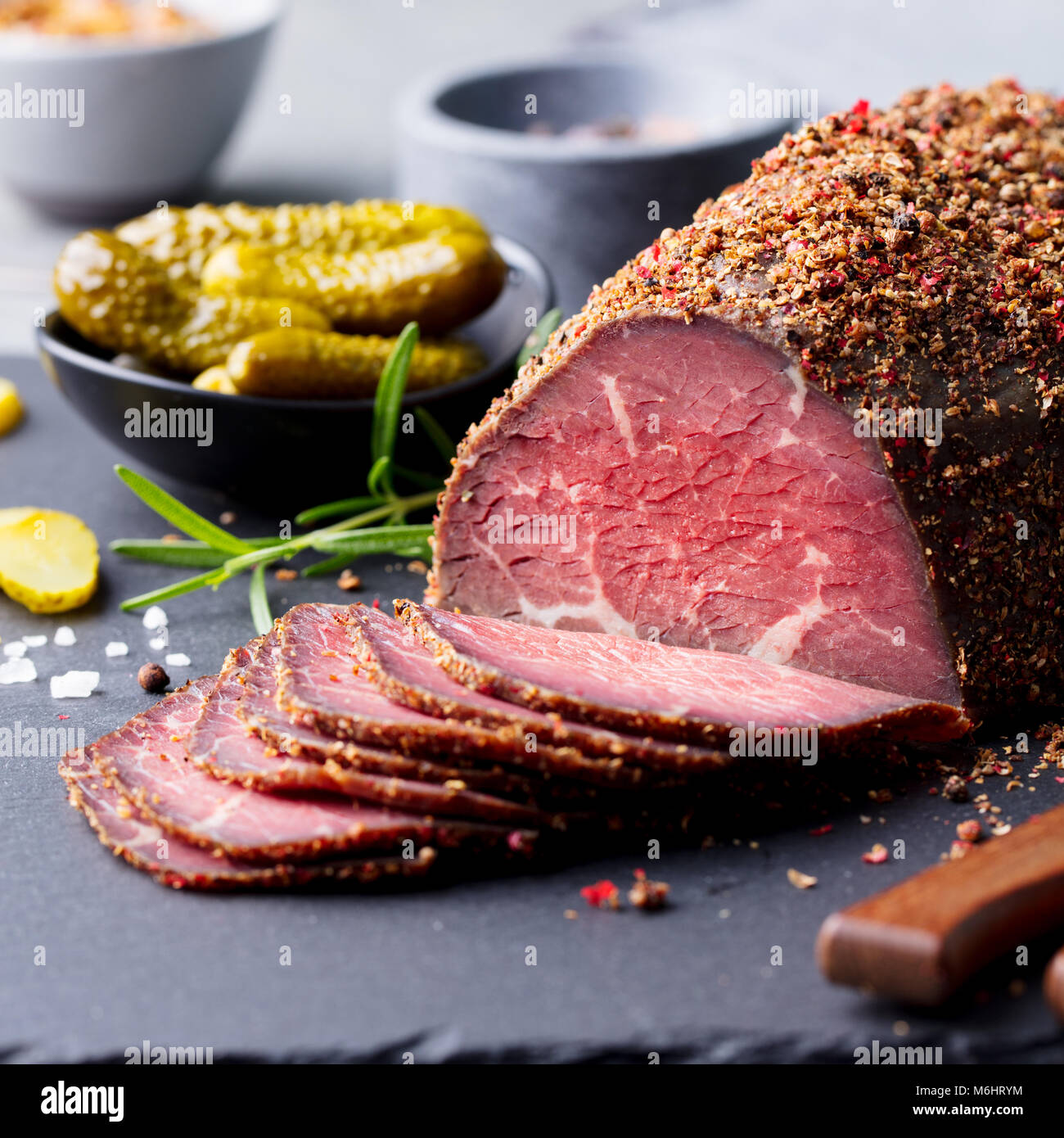 Roasted beef, pastrami on slate cutting board. Close up Stock Photo - Alamy