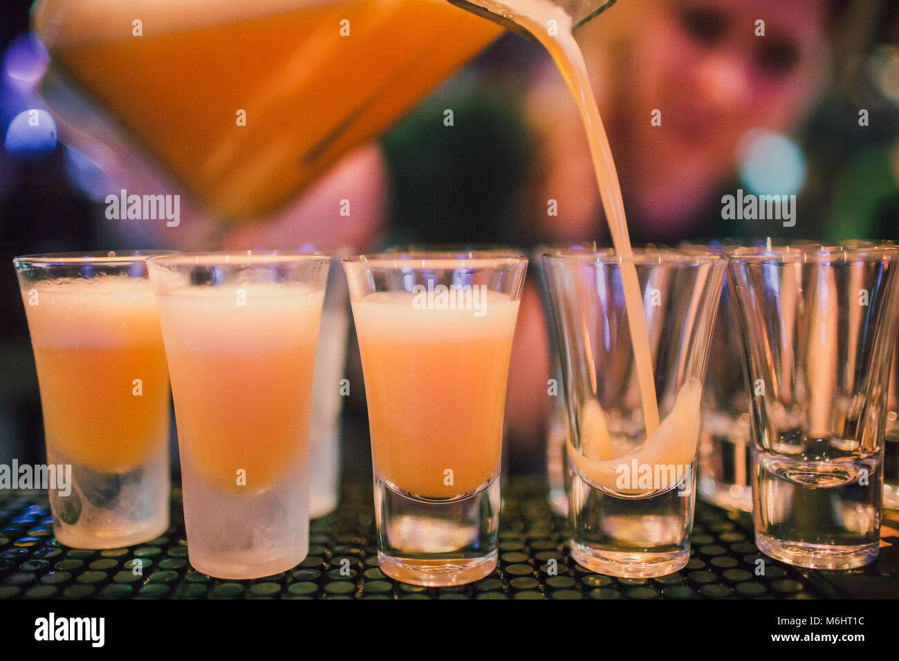 Beautiful row line of different colored alcohol cocktails with mint on ...