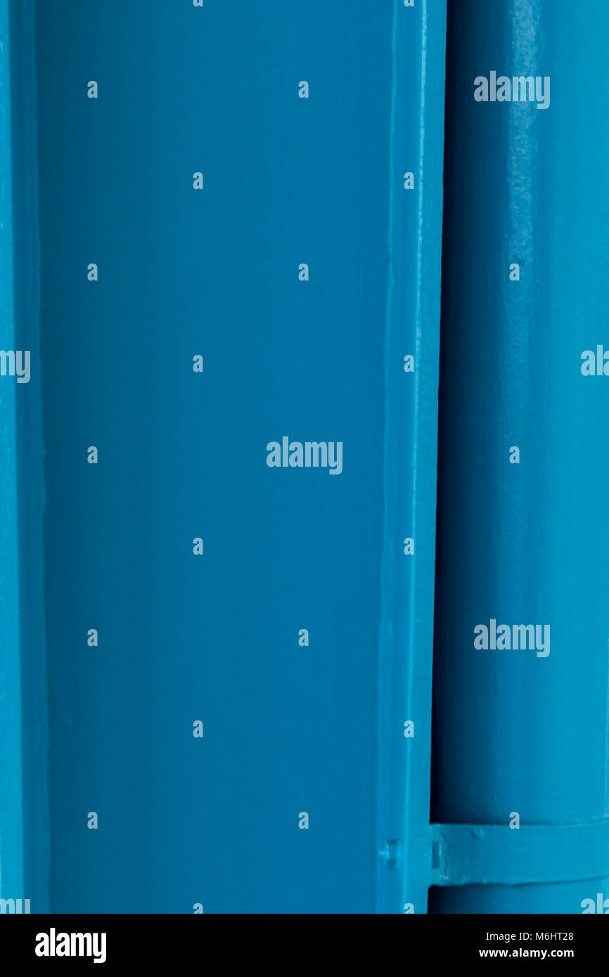 Close up of steel beam and pipe, painted blue. Shot at a subway station ...