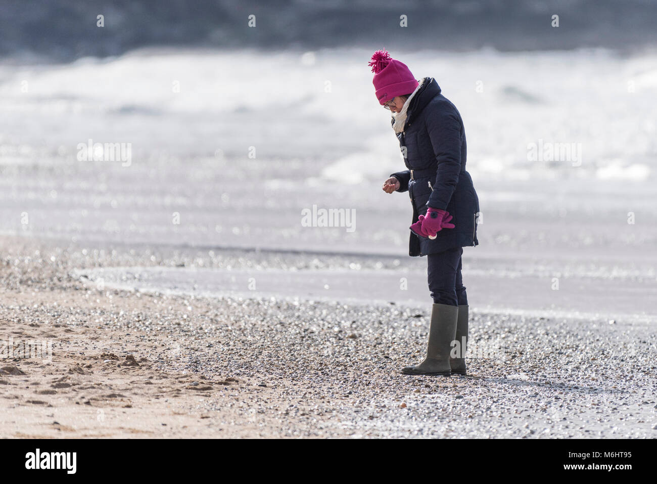 Woman standing beach cold hi-res stock photography and images - Alamy