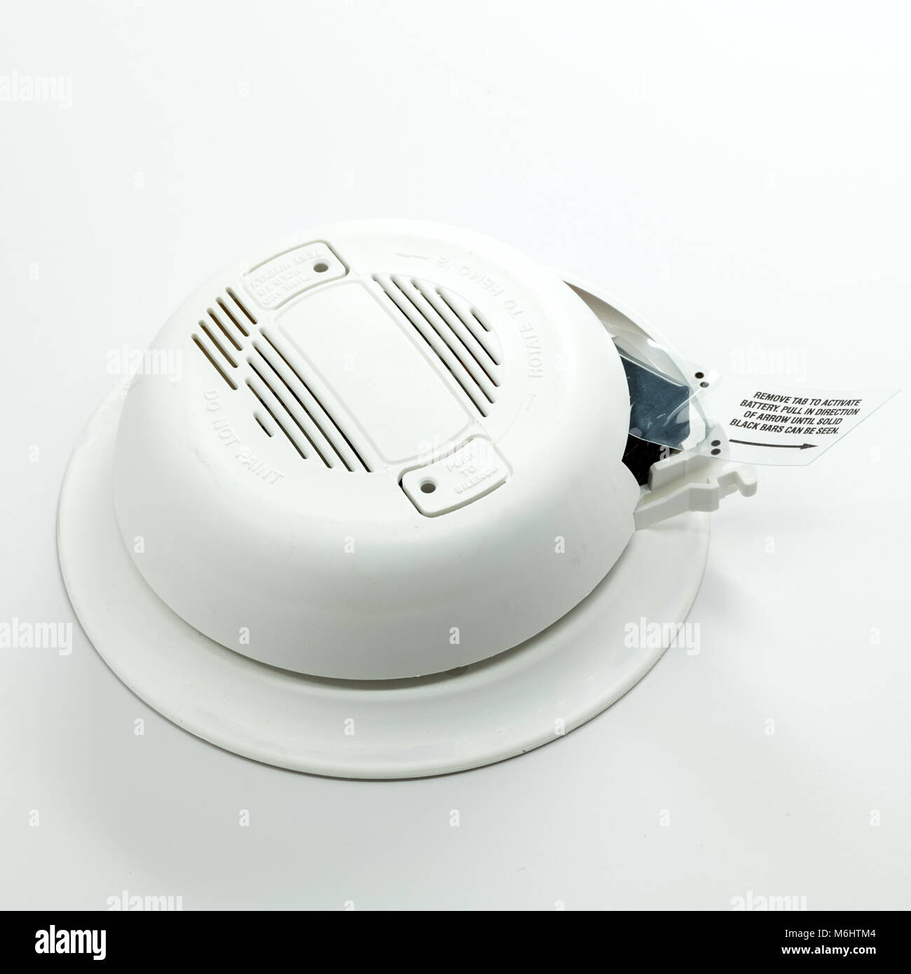 Small white smoke detector with a battery in it Stock Photo - Alamy