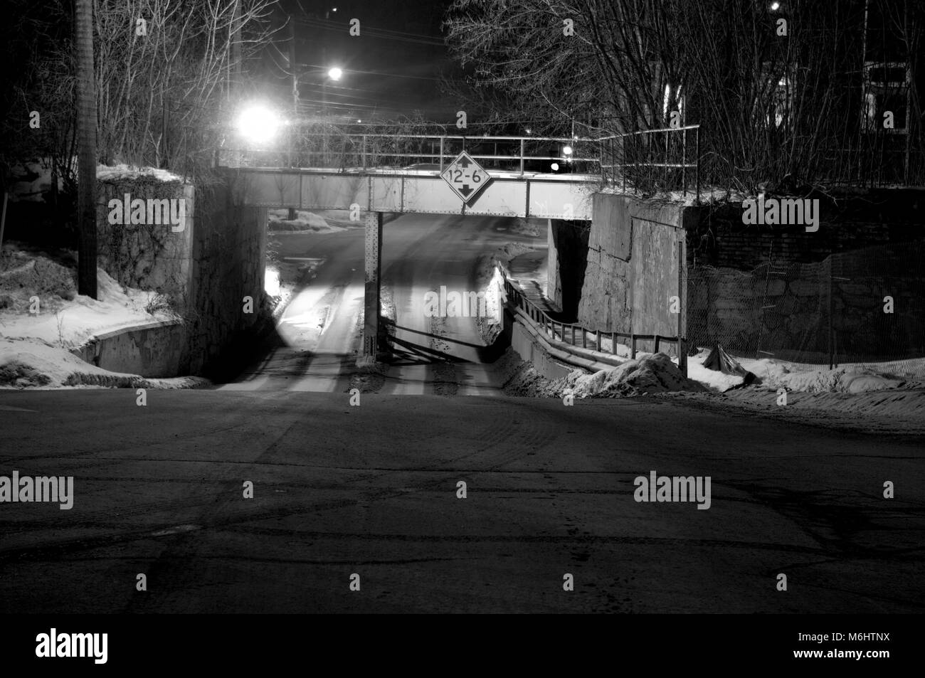 Railroad bridge over underpass at midnight Stock Photo - Alamy