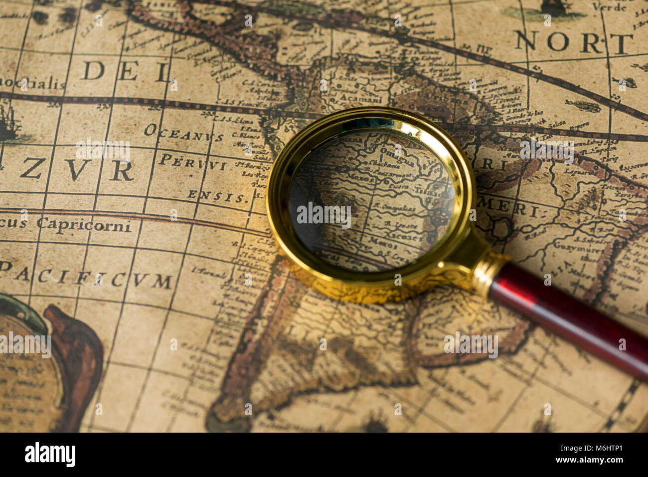 Retro magnifier with old map closeup Stock Photo - Alamy