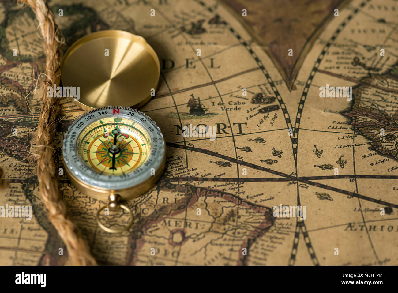 Old compass on vintage map with rope closeup. Retro stale Stock Photo ...