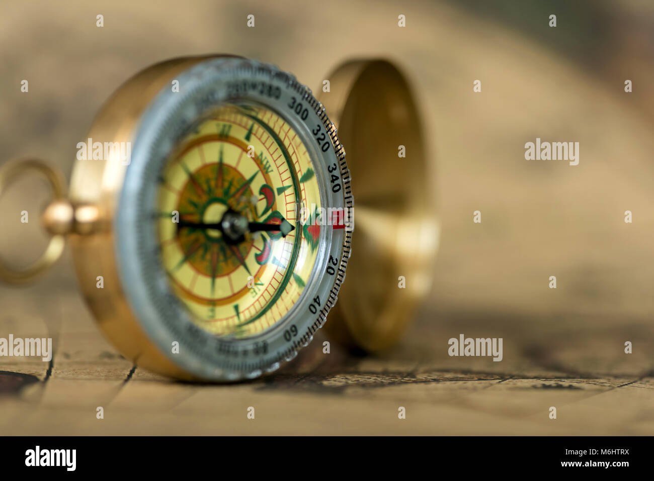 Old compass on vintage map. Retro stale Stock Photo - Alamy