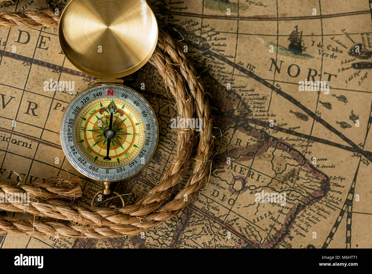 Old compass on vintage map with rope closeup. Retro stale Stock Photo ...