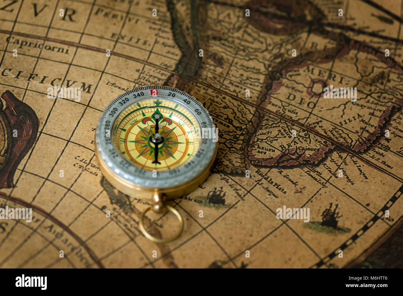 Old compass on vintage map. Retro stale Stock Photo - Alamy