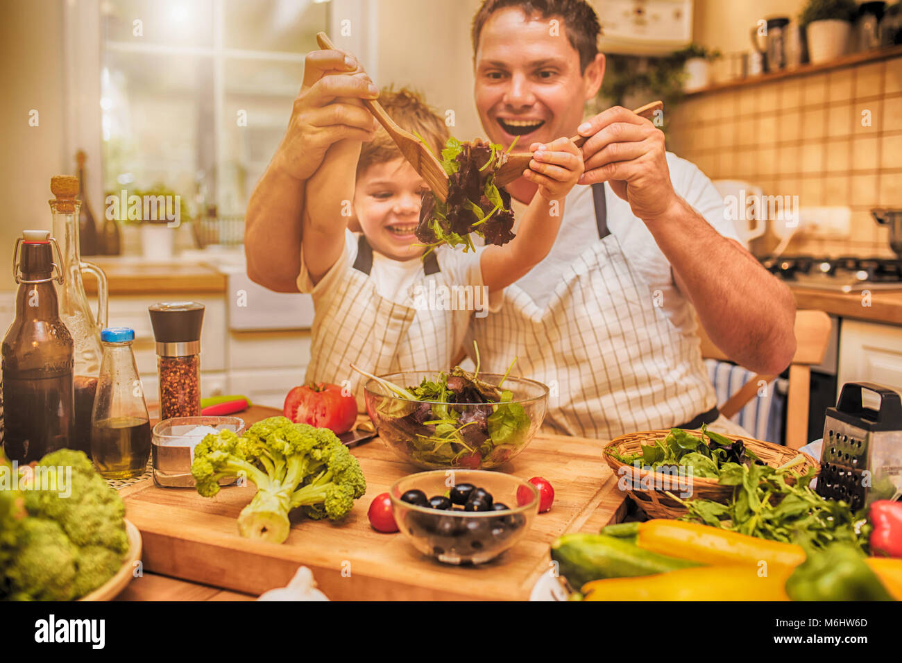 Chef man cooking on the kitchen with little son Stock Photo - Alamy