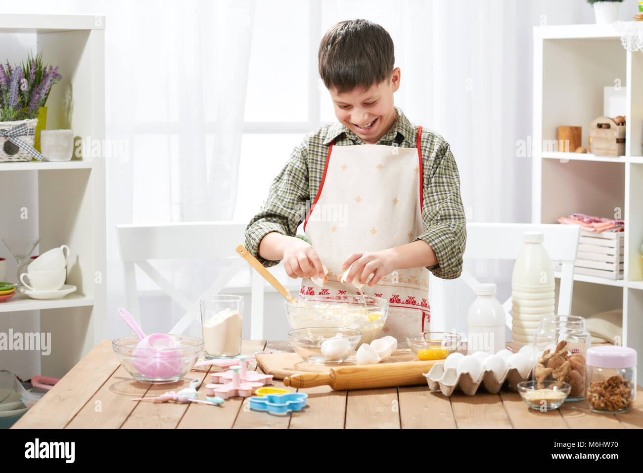 Boy cooking at home, making dough, buns and cookies Stock Photo - Alamy