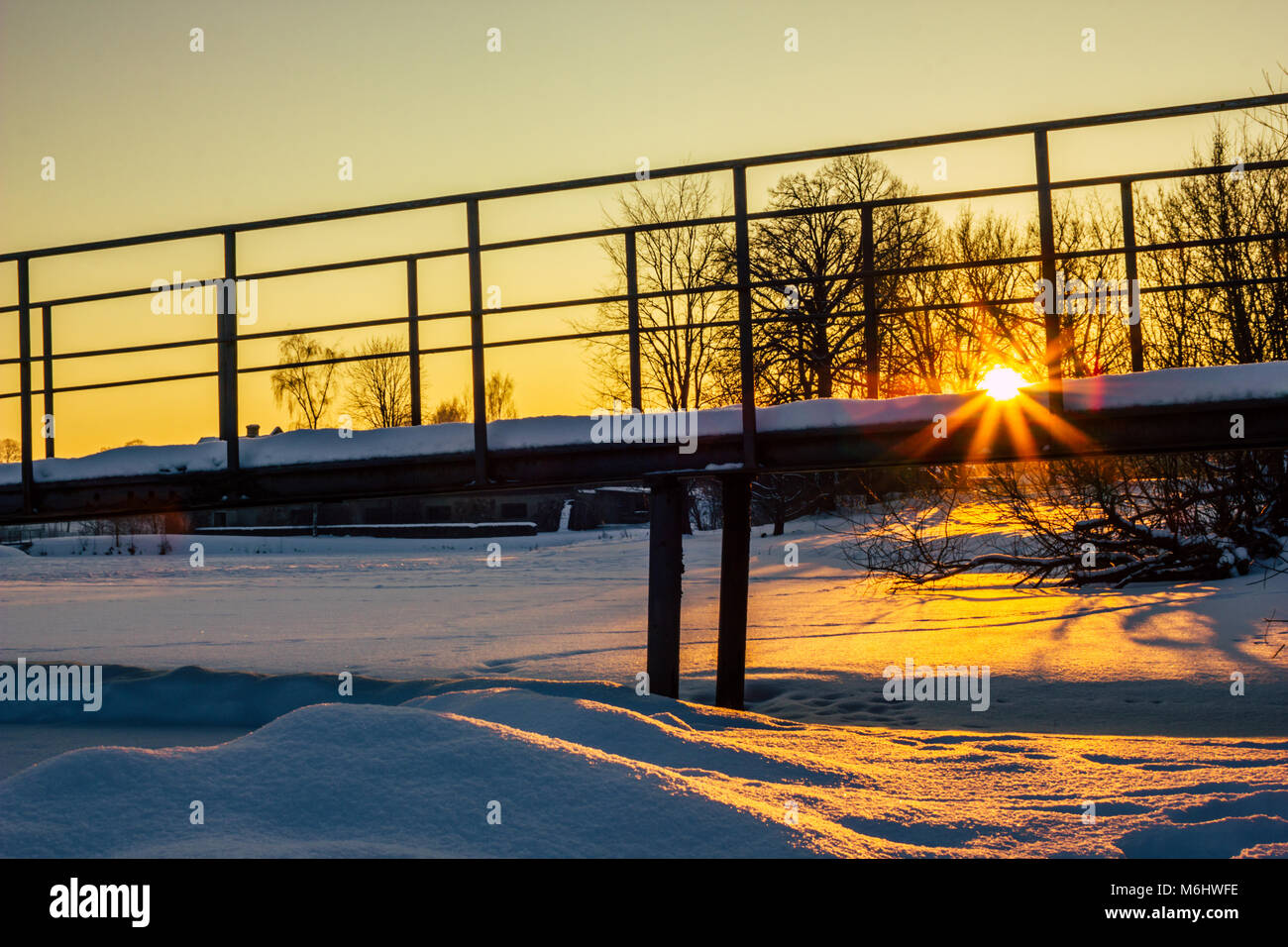 Snowy Bridge in a Countryside with the Sun Rays Gloving over it ...